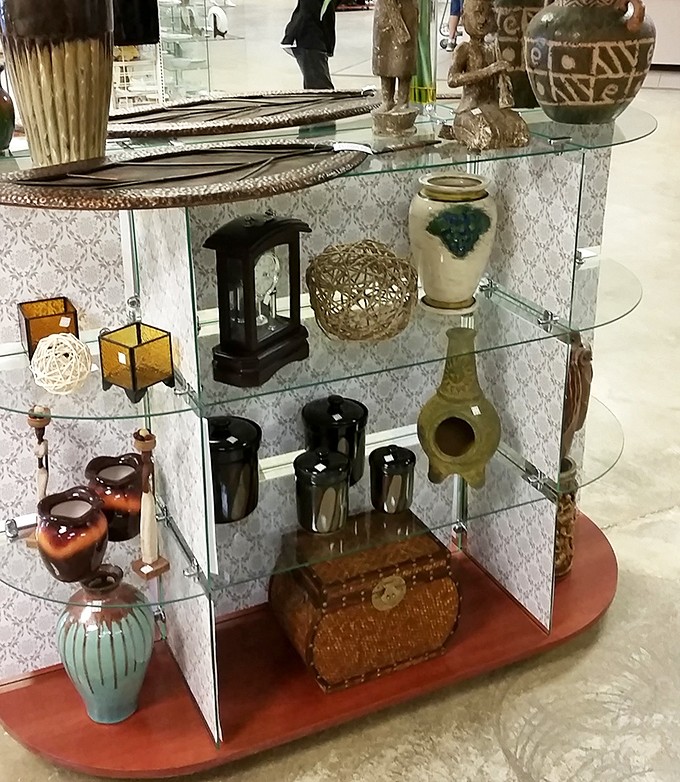 Glass shelves showcase treasures that once graced someone's mantel and now await adoption into your eclectic collection.