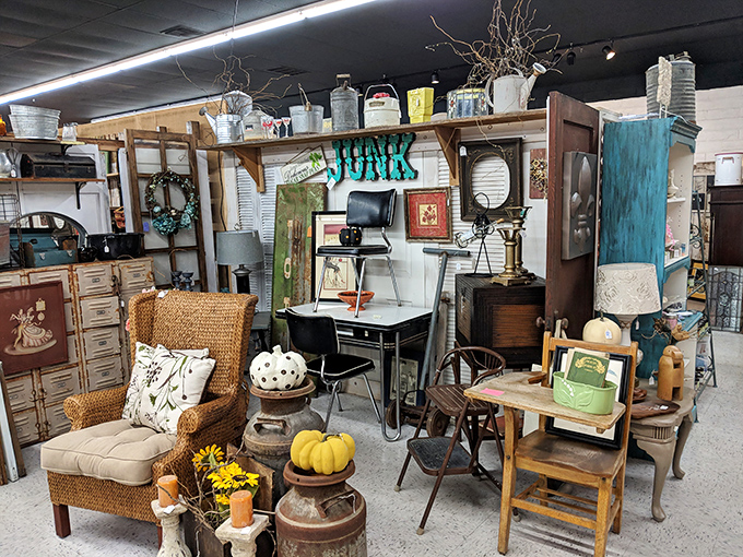 A farmhouse-chic display that would make Joanna Gaines swoon, complete with wicker chair and seasonal pumpkins for that perfect autumn vibe.