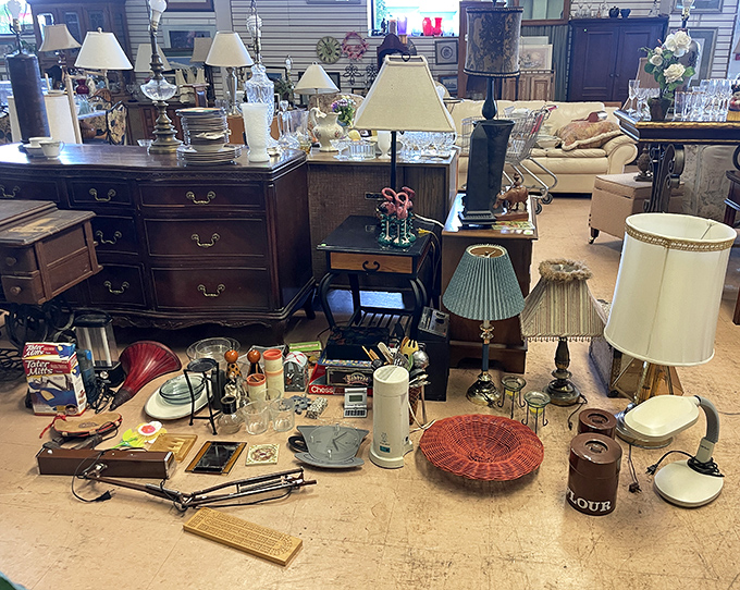 Curated collections of glassware, figurines, and vintage decor await new homes. That white ceramic lamp would cost a fortune at a designer store.
