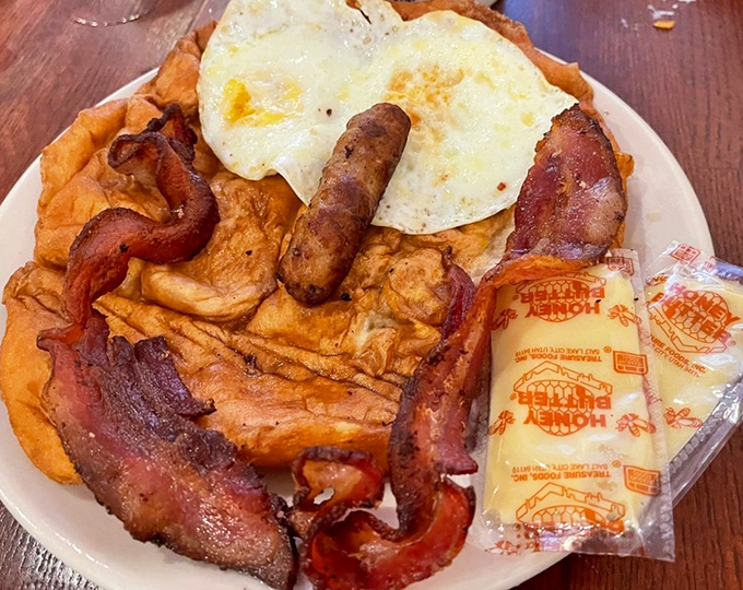 Breakfast nirvana achieved: crispy bacon curves like smiles around golden hash browns, with sunny-side eggs completing this holy trinity of morning perfection.