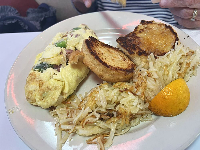 This isn't just breakfast&mdash;it's morning poetry on a plate. Golden hash browns, perfectly folded omelet, and toast that makes your home toaster seem obsolete.