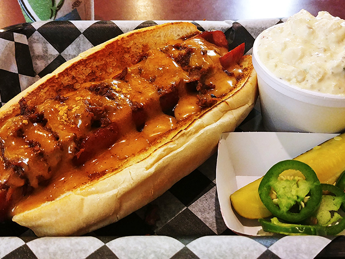 That's not just a hot dog &ndash; it's a smoke-kissed masterpiece lounging in a pillowy bun with potato salad standing by for backup. 