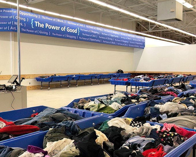 "The Power of Good" banner watches over a sea of potential. These sorting bins are like lottery tickets&mdash;you never know what winning item you'll find.