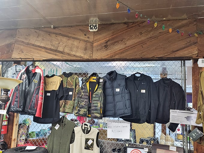 Military jackets and outdoor gear hanging like historical flags. Each one with pockets deep enough to hide your flea market snacks and negotiation strategy notes.