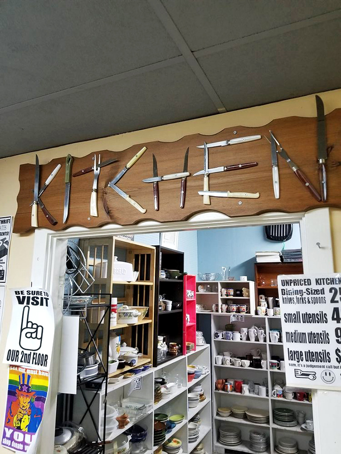 "KITCHEN" spelled out in vintage knives announces a room where your grandmother's favorite Pyrex patterns await new homes.