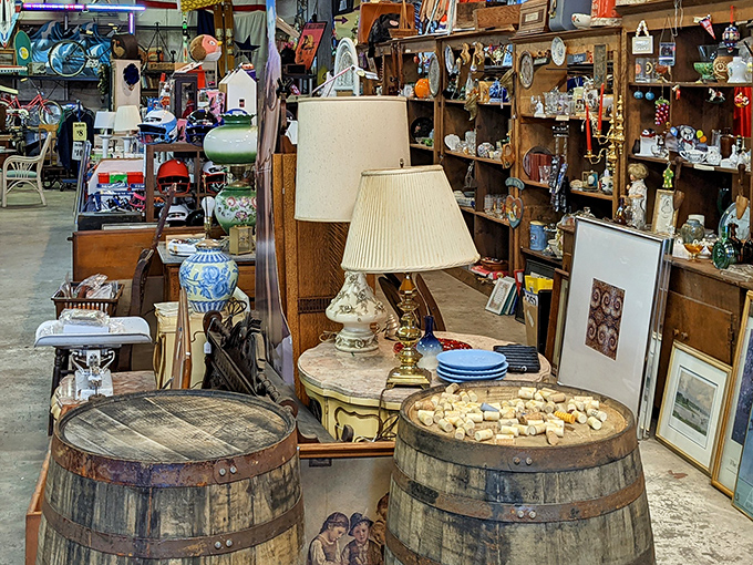Wooden barrels repurposed as display tables showcase vintage lamps and porcelain treasures&mdash;proving everything here deserves its second act.