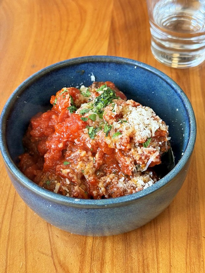These meatballs aren't just swimming in sauce&mdash;they're doing the backstroke in tomato heaven, showered with herbs and parmesan.