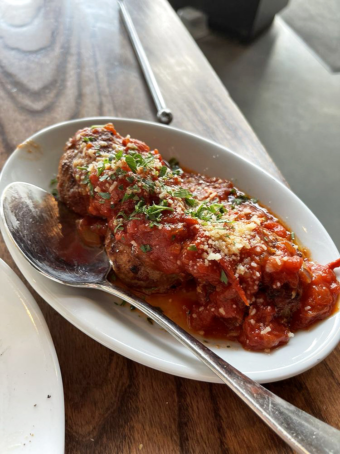 These meatballs aren't just food; they're an event. Bathed in that vibrant tomato sauce, they're the kind of dish you'd request for your last meal.