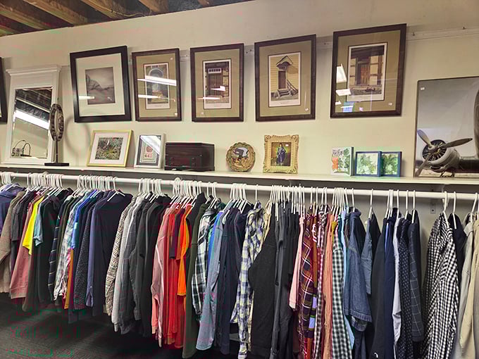 Men's shirts lined up like soldiers ready for duty, beneath artwork that's probably seen more Maine living rooms than a Patriots game.