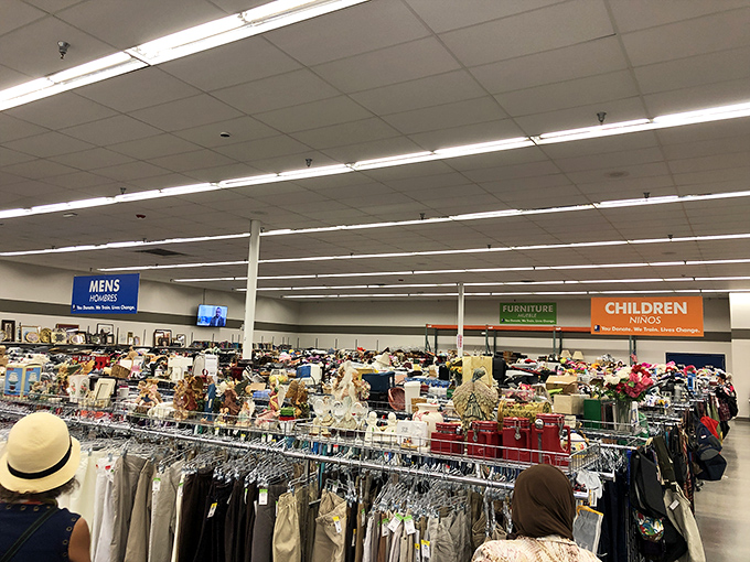 A shopper's straw hat bobs through the sea of shirts&mdash;the universal uniform of serious thrift explorers.