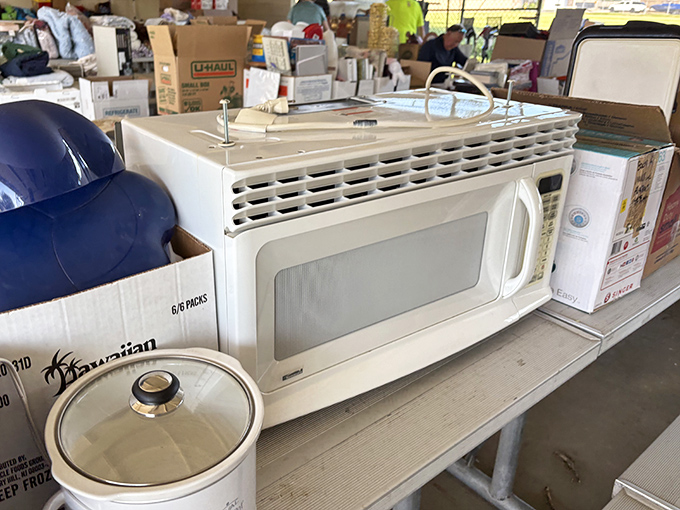 Kitchen appliances await their second act. That microwave might have heated someone's wedding leftovers before finding its way here.