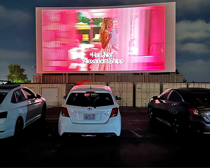 Movie magic comes alive as the massive screen glows in the darkness, turning ordinary cars into front-row theater seats.