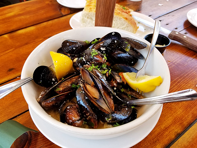 These mussels aren't just cooked—they're transformed into oceanic jewels, each shell revealing a perfect morsel worth fighting over with your dining companions.