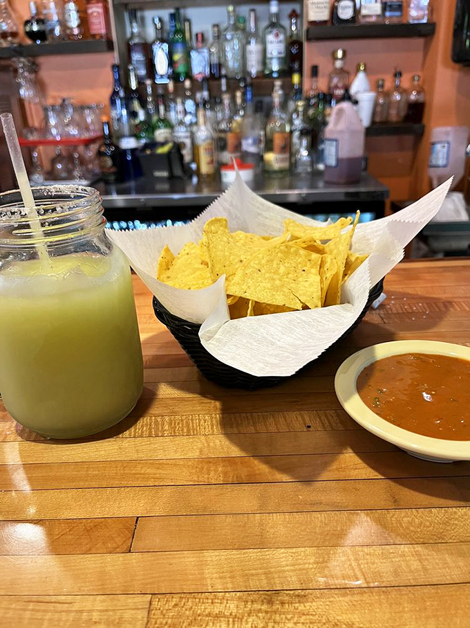 That mason jar of lime-green goodness isn't just a margarita&mdash;it's vacation in a glass, perfectly paired with chips that arrive warm enough to make you wonder if they have chip telepathy.