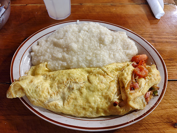 This omelet practically winks at you from the plate, while those creamy grits stand by like a loyal sidekick ready for their moment of glory.