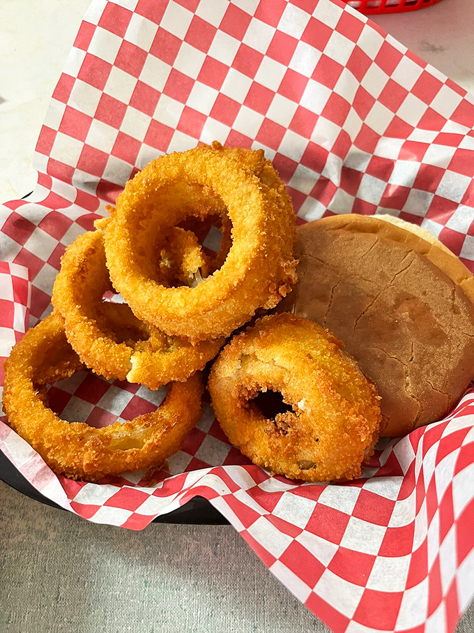 Golden-brown onion rings with the perfect crunch-to-tenderness ratio, served with a pillowy bun&mdash;proof that simplicity, when done right, is culinary poetry.