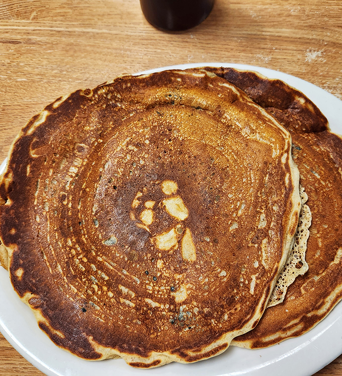 Golden-brown pancakes with that perfect crisp edge and fluffy center. The kind that make you question why anyone bothers with fancy brunch.