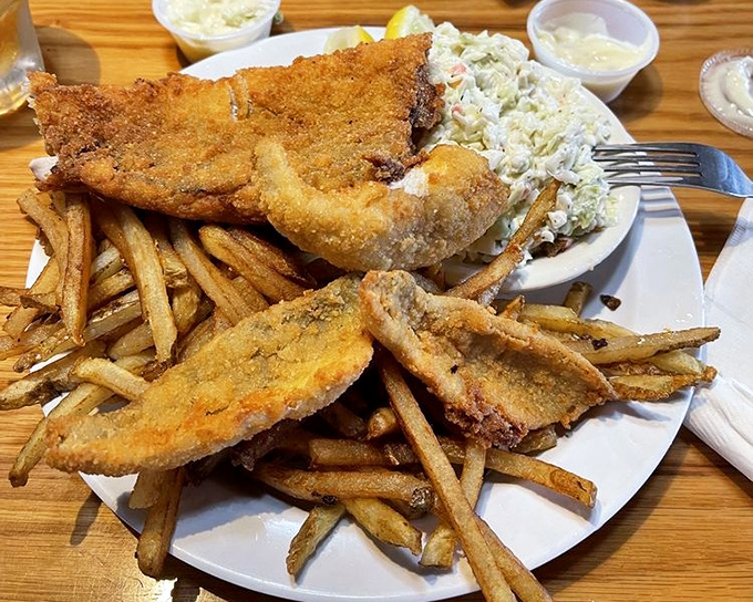 Golden-fried perfection on a plate. This walleye dinner with those famous greasy fries and creamy coleslaw is Ohio's answer to coastal seafood snobbery.