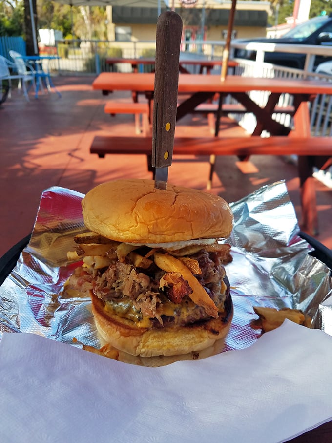 Behold the architectural marvel that is Uncle Chicken's pulled pork sandwich&mdash;where smoke meets sweet in a handheld masterpiece that demands a knife for support.