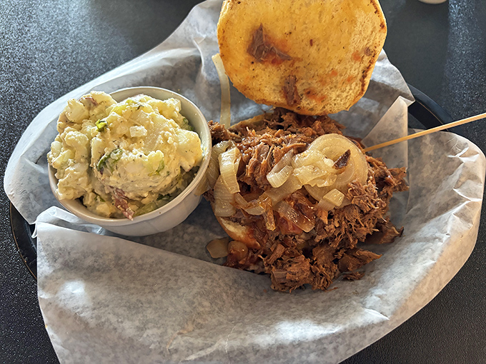 This isn't just pulled pork – it's a masterclass in barbecue artistry, paired with potato salad that would make your grandmother both jealous and proud.