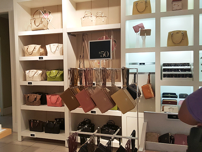 Handbag heaven where designer dreams come with earthly price tags. That $50 sign isn't a typo—it's the sound of your credit card sighing with relief.
