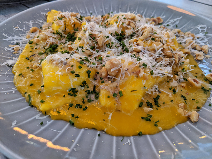 Sunshine on a plate! These golden-hued ravioli topped with fresh herbs and parmesan are what pasta dreams are made of.