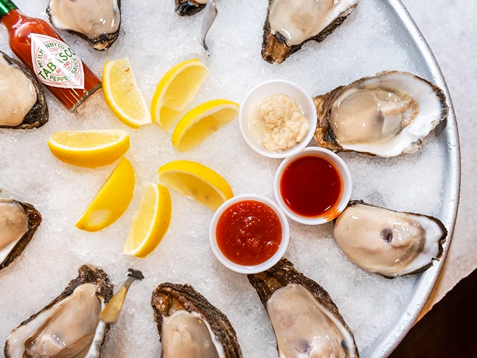 These oysters aren't just served; they're presented like jewelry on ice with citrus wedges and sauces standing by for their grand debut.