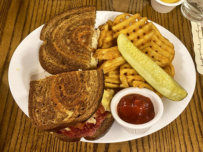 Not just any Reuben &ndash; this is sandwich architecture at its finest. Perfectly grilled bread, generous corned beef, and that pickle spear standing guard like it knows something special is happening. 