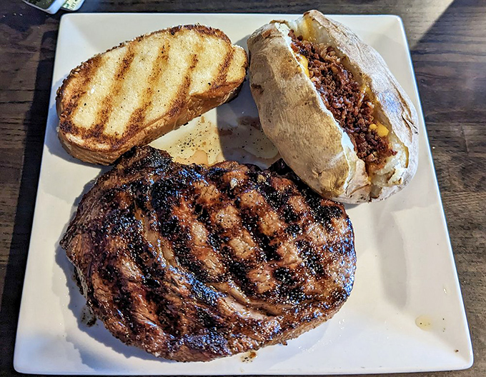 Behold the star of the show: a perfectly grilled ribeye with those coveted grill marks that whisper, "Yes, this is the right decision."