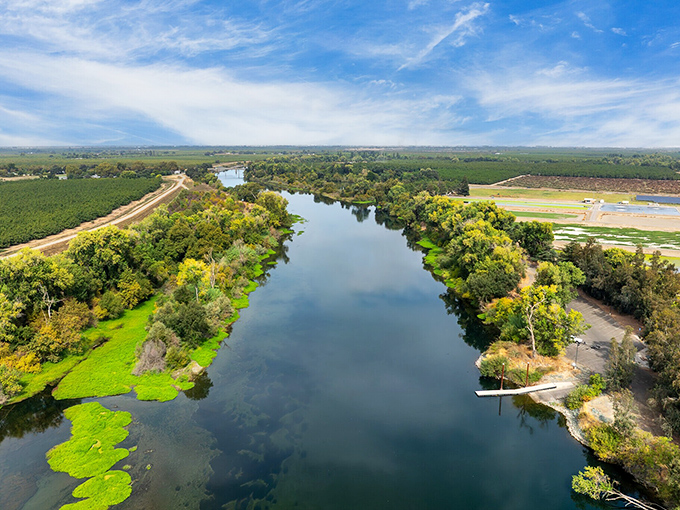 The Feather River flows lazily past farmlands, offering peaceful kayaking adventures where the only traffic is an occasional duck family.