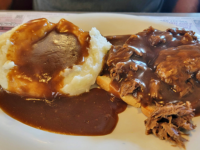 This isn't just pot roast &ndash; it's a hug on a plate. Tender meat swimming in rich gravy alongside fluffy mashed potatoes.