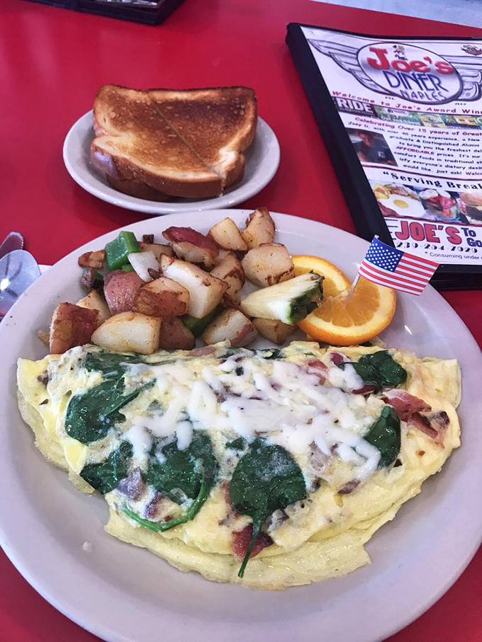 This isn't just an omelet&mdash;it's a love letter to breakfast. Spinach and cheese embrace like old friends while those home fries deserve their own fan club.