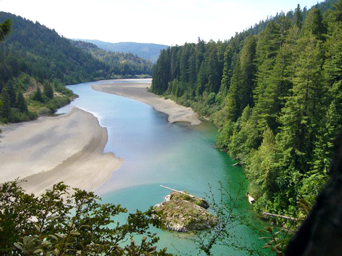 The Eel River cuts through the landscape like nature's own infinity pool. Emerald waters reflect centuries of quiet forest wisdom.