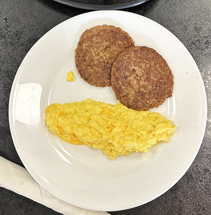 Scrambled eggs so fluffy they might float away if not anchored by those perfectly golden hash browns. Breakfast fundamentals executed with care.