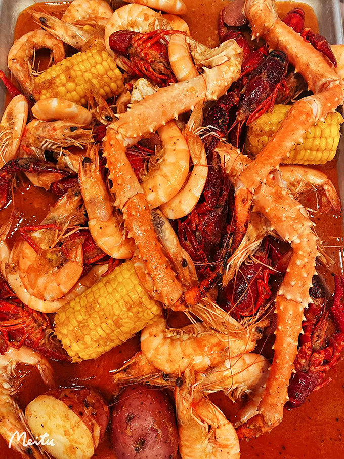 Seafood boil heaven! Plump shrimp, crawfish, corn, and potatoes swimming in spiced glory. This isn't just dinner; it's a delicious full-contact sport.