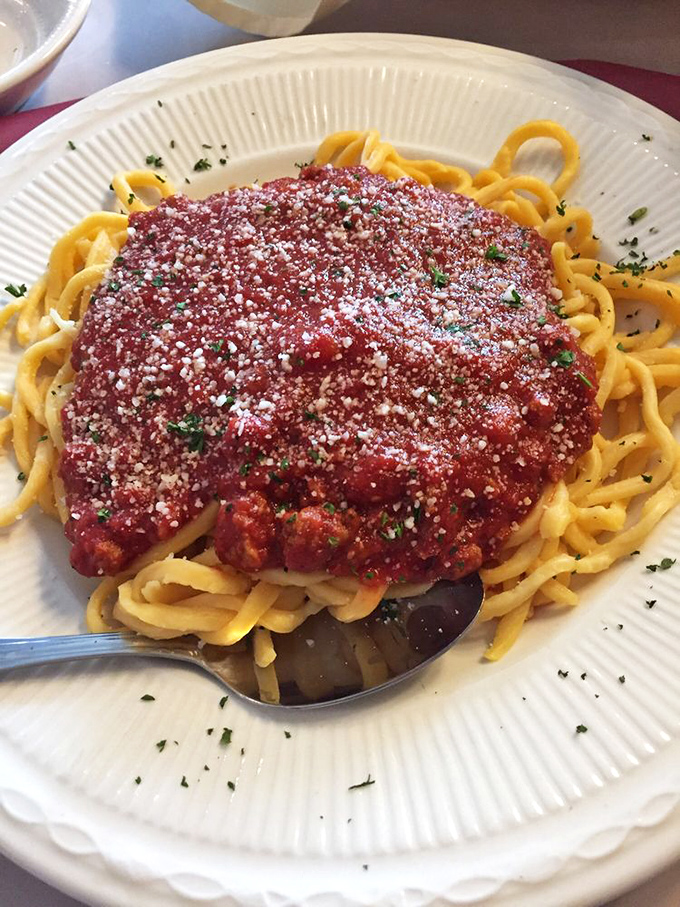 This isn't just spaghetti&mdash;it's a mountain of homemade pasta crowned with rich sauce and a snowfall of parmesan that whispers, "Take your time with me."