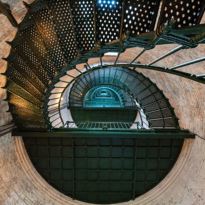The spiral staircase winds like a nautical DNA strand, each step a connection to the lighthouse keepers who made this climb multiple times daily.