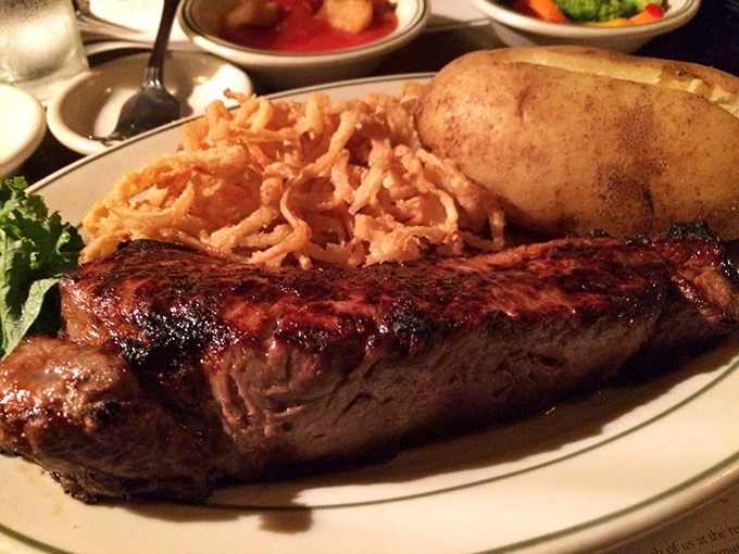 This isn't just a steak&mdash;it's a masterpiece with a side of crispy onion strings. The kind of meal that makes vegetarians question their life choices.