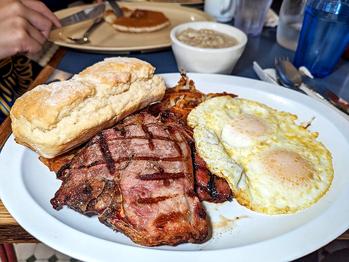 This isn't just steak and eggs; it's a carnivore's love poem served on a white plate. The grill marks tell stories of perfect timing.
