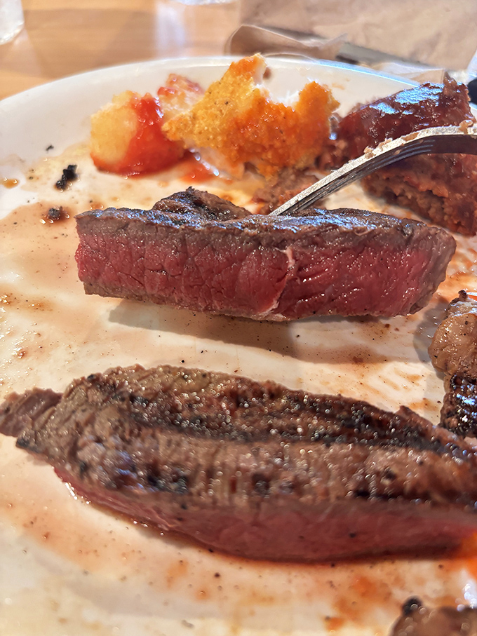 Perfectly cooked steak slices that show just the right amount of pink in the middle, proving buffets can actually respect good beef.