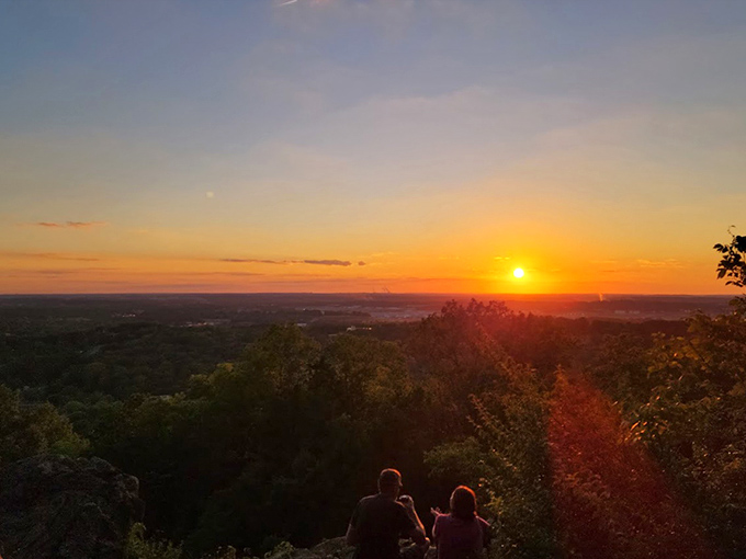 Magic hour takes on new meaning when witnessed from this height. Two silhouetted visitors prove some moments are better shared than Instagrammed.