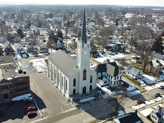 This stately white church stands sentinel over Huntington's neighborhoods, its soaring spire reaching skyward like the community's hopes and dreams.