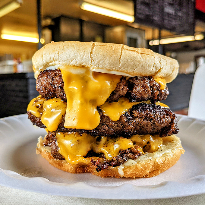 Behold the tower of power! This triple cheeseburger isn't just a meal, it's a monument to American excess done absolutely right.