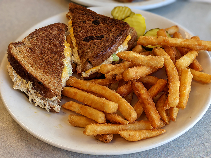 The humble tuna melt, perfected. Golden-brown bread, generous filling, and those crispy fries that somehow taste better in diners.