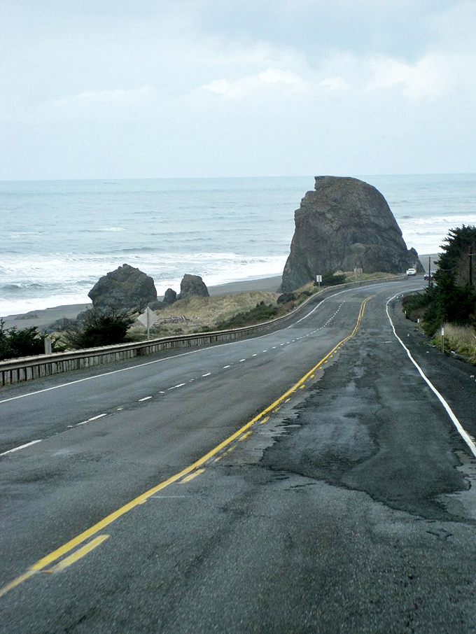 The road whispers, "Slow down, the view isn't going anywhere." Massive sea stacks stand guard as Highway 101 makes its graceful curve.