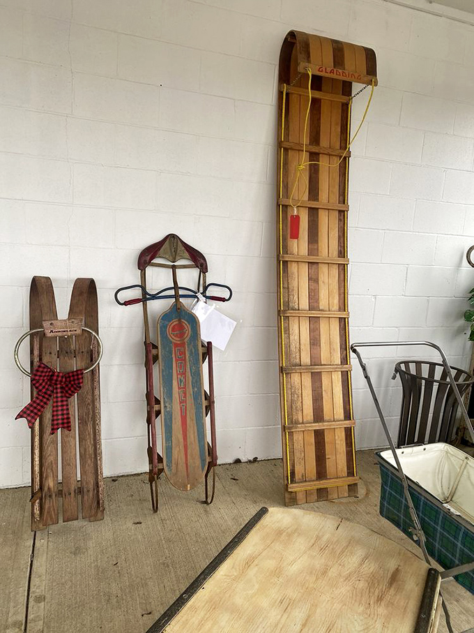 Vintage sleds lean against the wall like retired Olympic athletes, each with stories of snowy hills conquered decades ago.