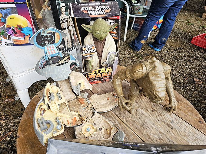 Yoda watches over a galaxy of Star Wars collectibles. The Force of nostalgia is strong with this booth, tempting fans of all generations.