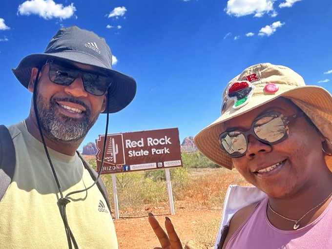 "We made it!" Visitors celebrate reaching the park entrance. That smile says, "The car AC is officially off duty&mdash;adventure mode activated!"