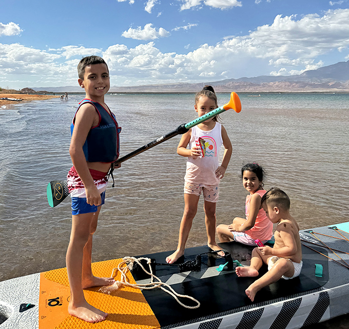 Family paddleboard adventures where memories are made. The kids' smiles are as bright as that impossibly blue Utah water.
