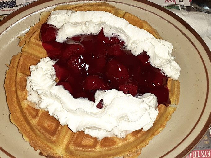 This waffle doesn't just have toppings—it's wearing a cherry crown with whipped cream robes. Breakfast royalty that's worth bowing down to.